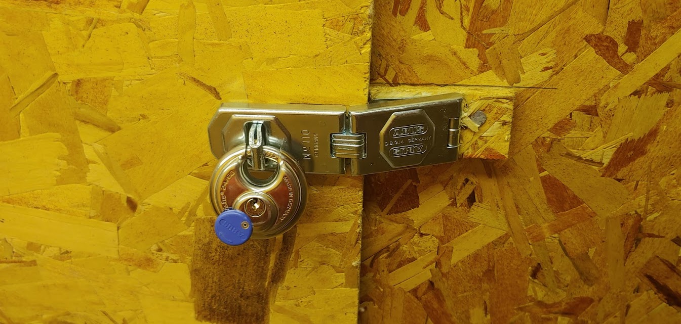 An Abus Diskus padlock I installed. The thin plywood door could still ...